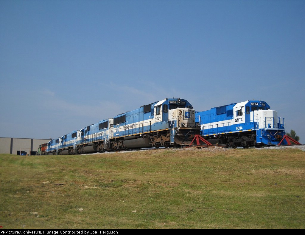 EMDX 9089 with others a couple BNSF SW1000's (and a fresh paint GMTX SW1000 ex BNSF) sun ...